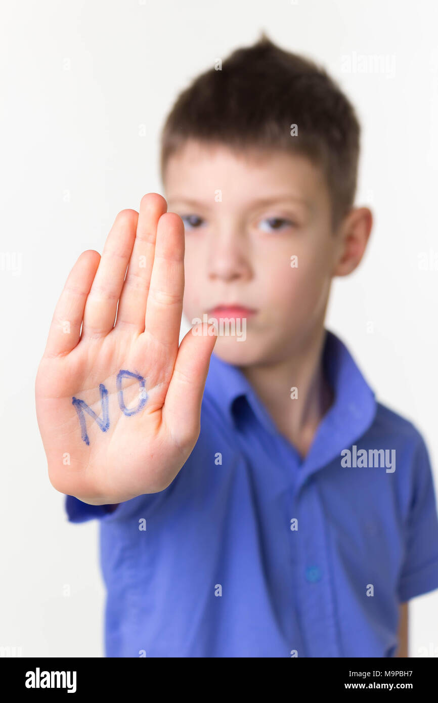 Teen little boy making stop sign with word no on open palm Stock Photo ...
