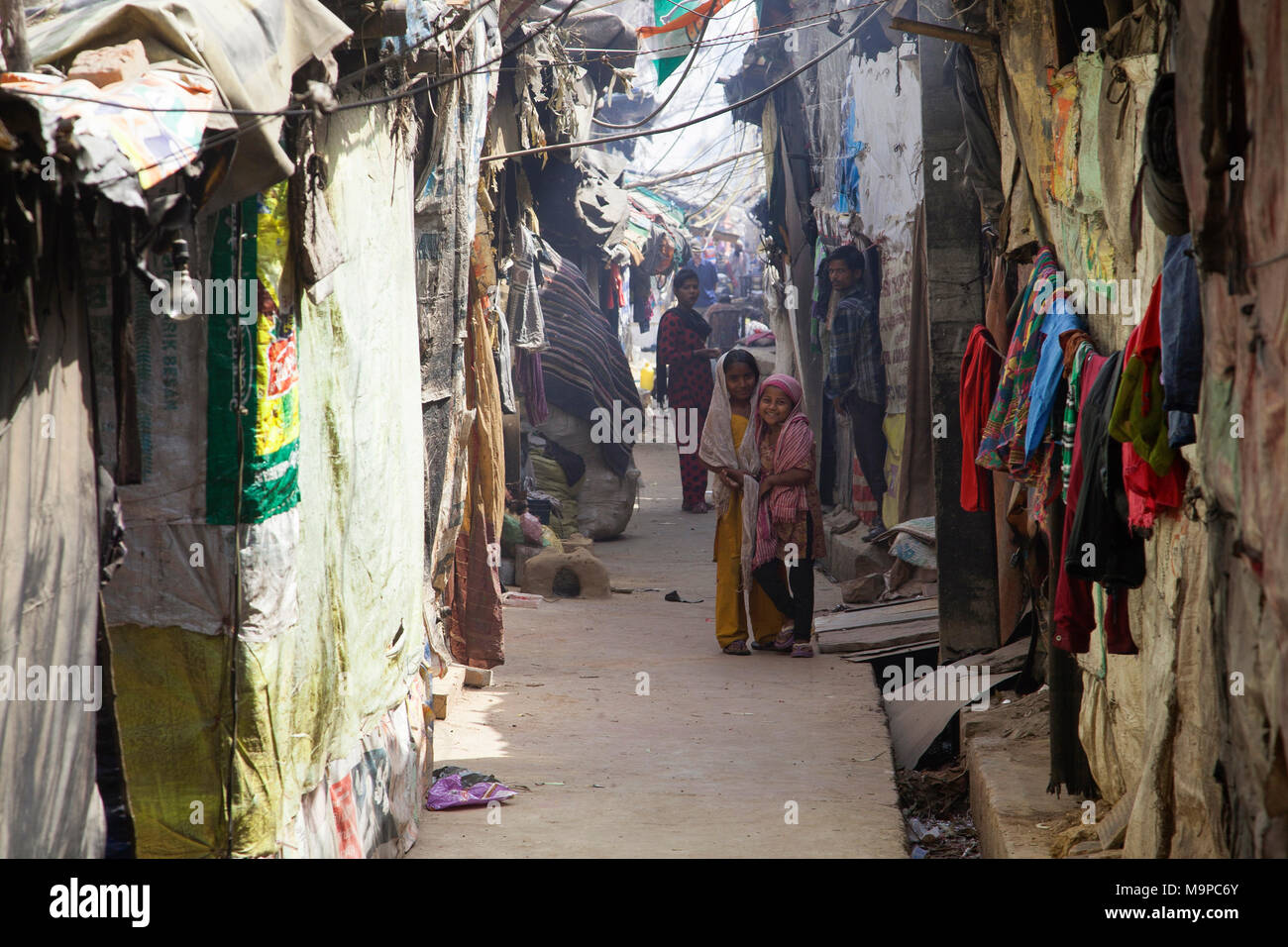 Children in the slum between dwellings at the Ghazipur garbage dump ...
