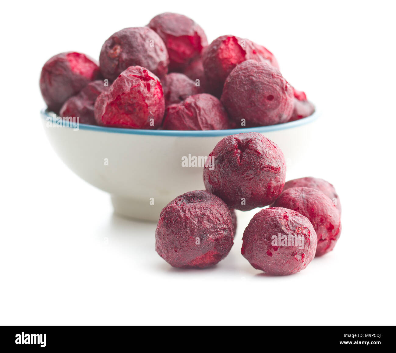 Freeze dried cherries in bowl isolated on white background Stock Photo ...