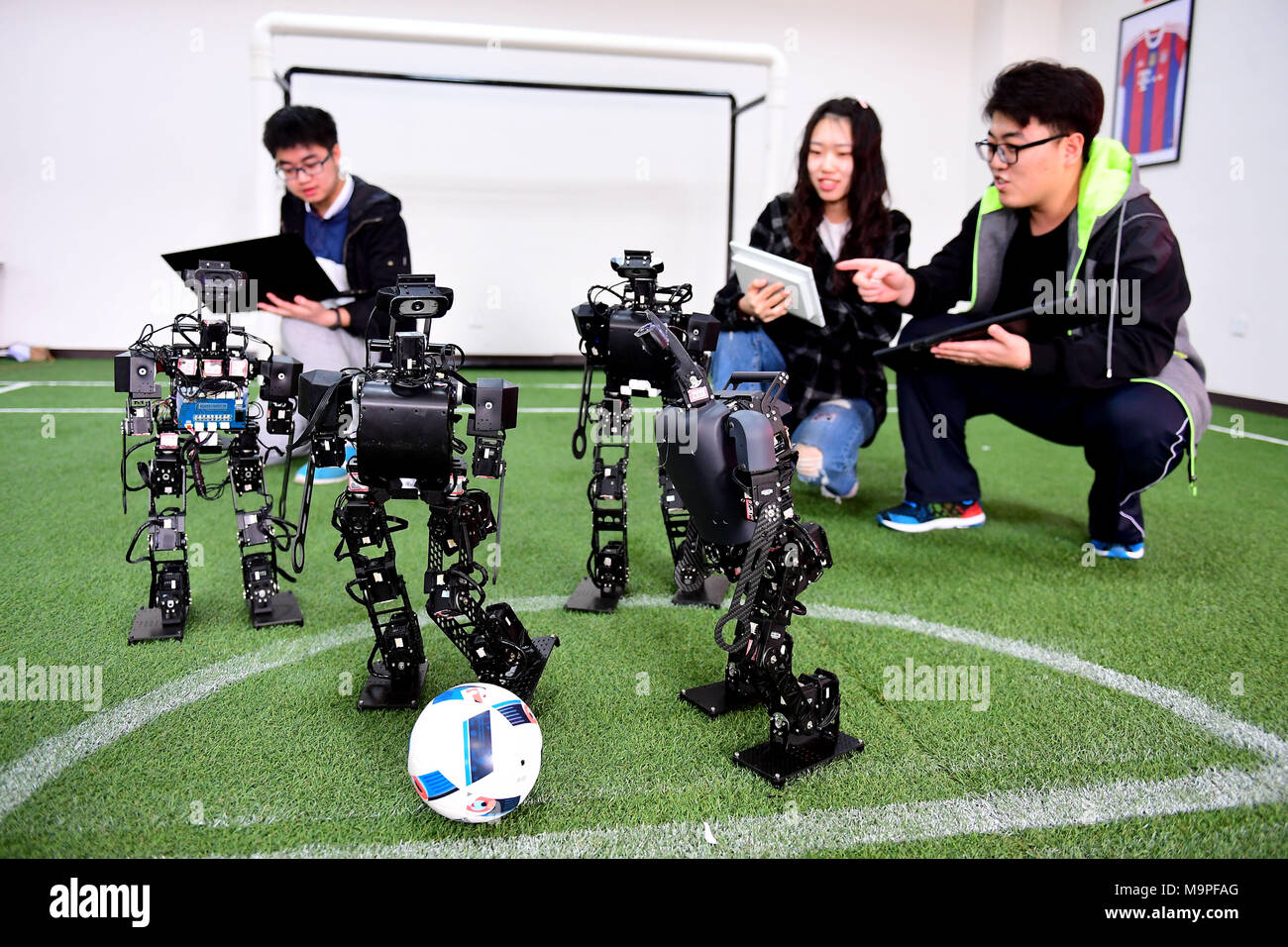 Shenyang, China. 27th Mar, 2018. The robots playing football before ...