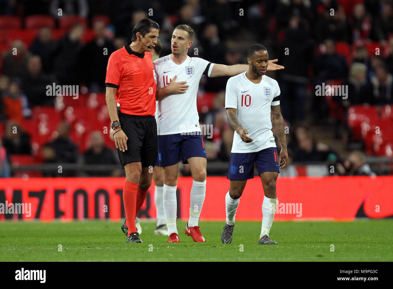 London, UK. 27th March, 2018. Jordan Henderson of England argues with ...