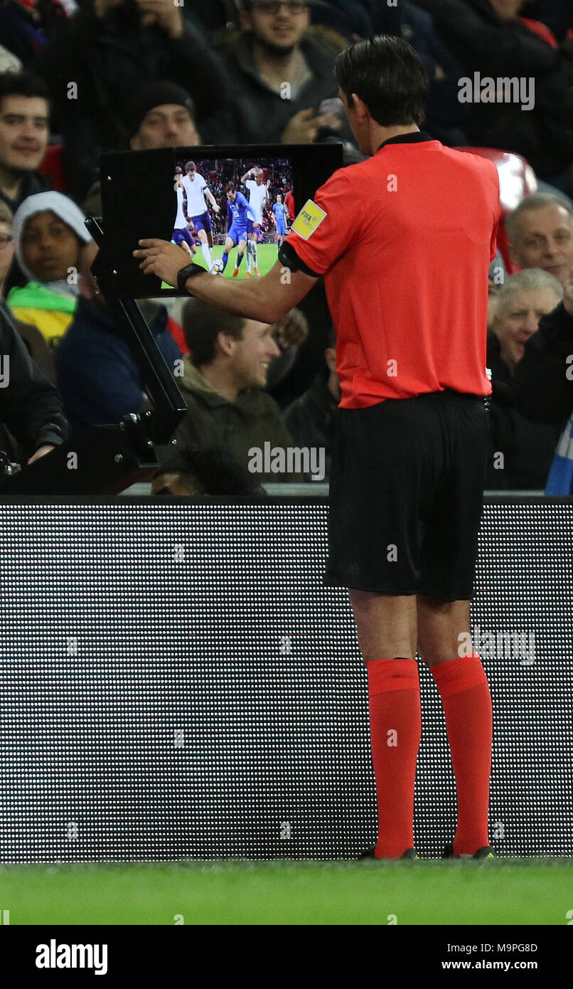 London, UK. 27th March, 2018. Referee Deniz Aytekin refers to VAR ...