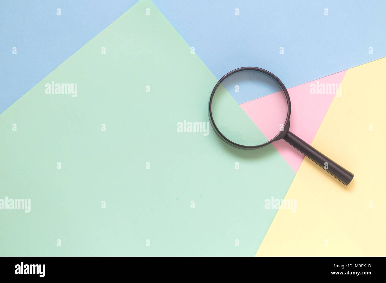 Magnifying glass against colorful pastel background flat lay minimal ...