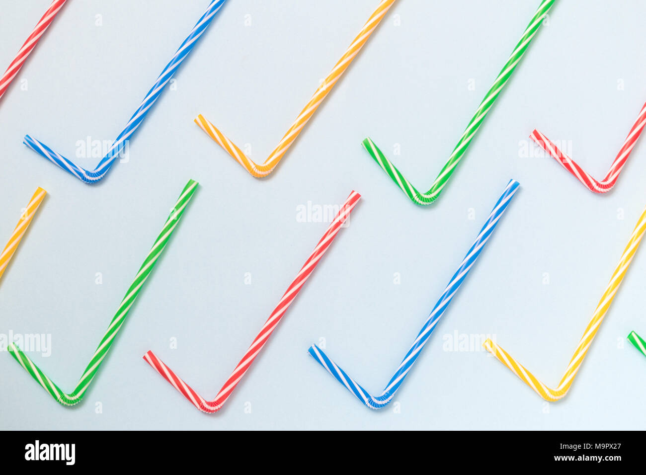 Pattern made of colorful drinking straws on pastel blue background ...