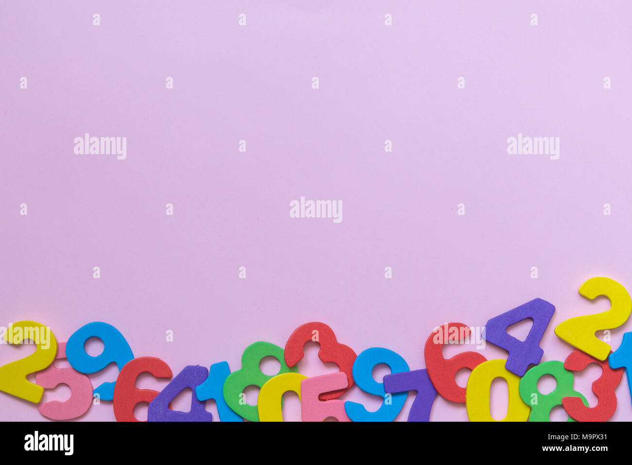 Colorful wooden numbers on pastel pink background minimal creative ...