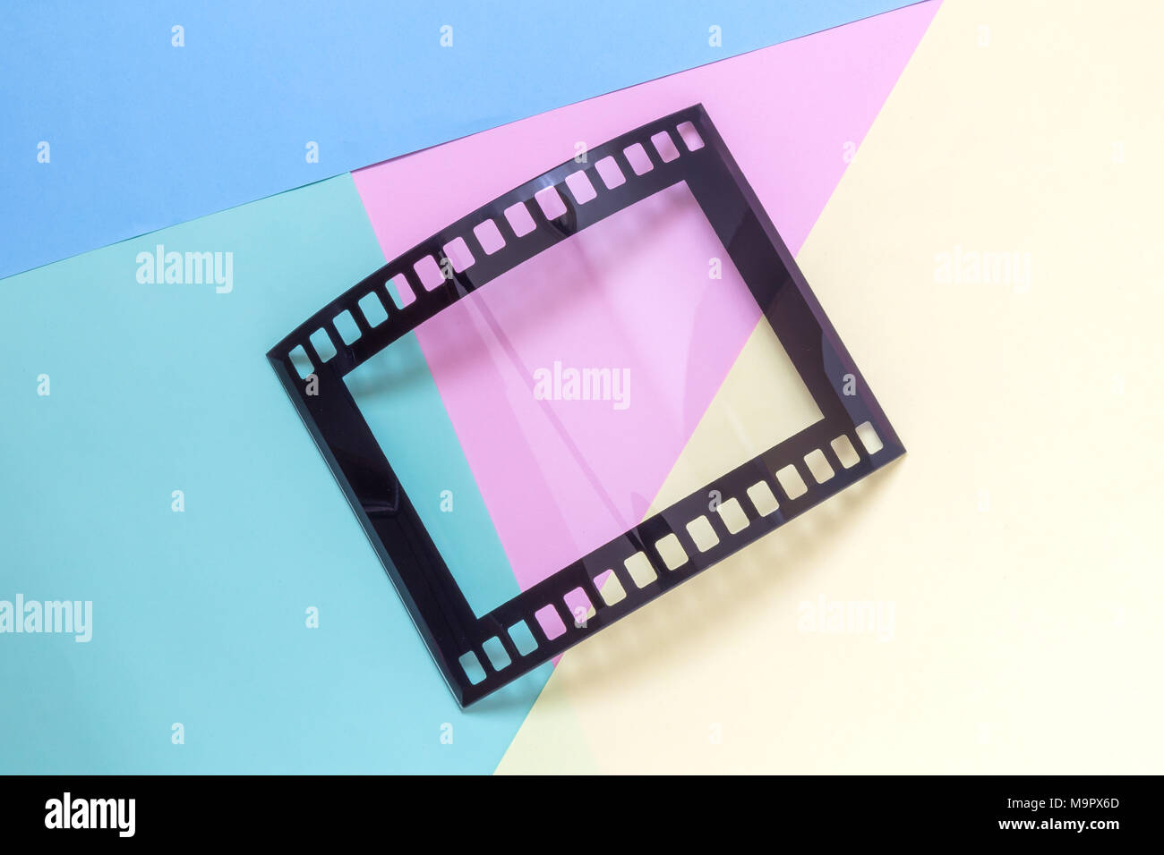 Retro negative film blank photo frame on colorful pastel background ...