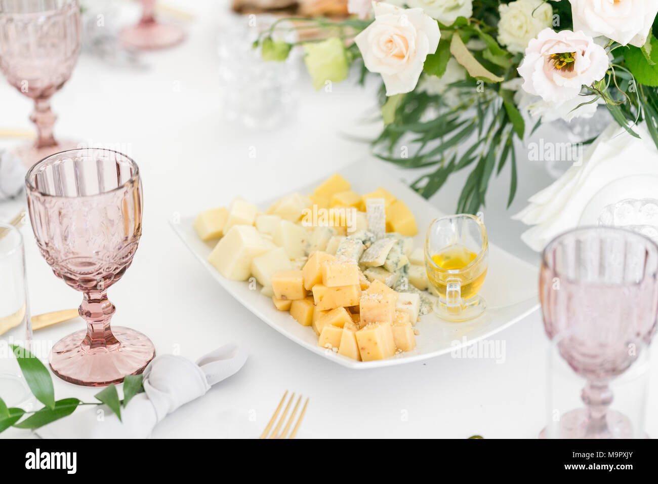 Cheese platter. Plate with food on the table, snacks at the banquet ...