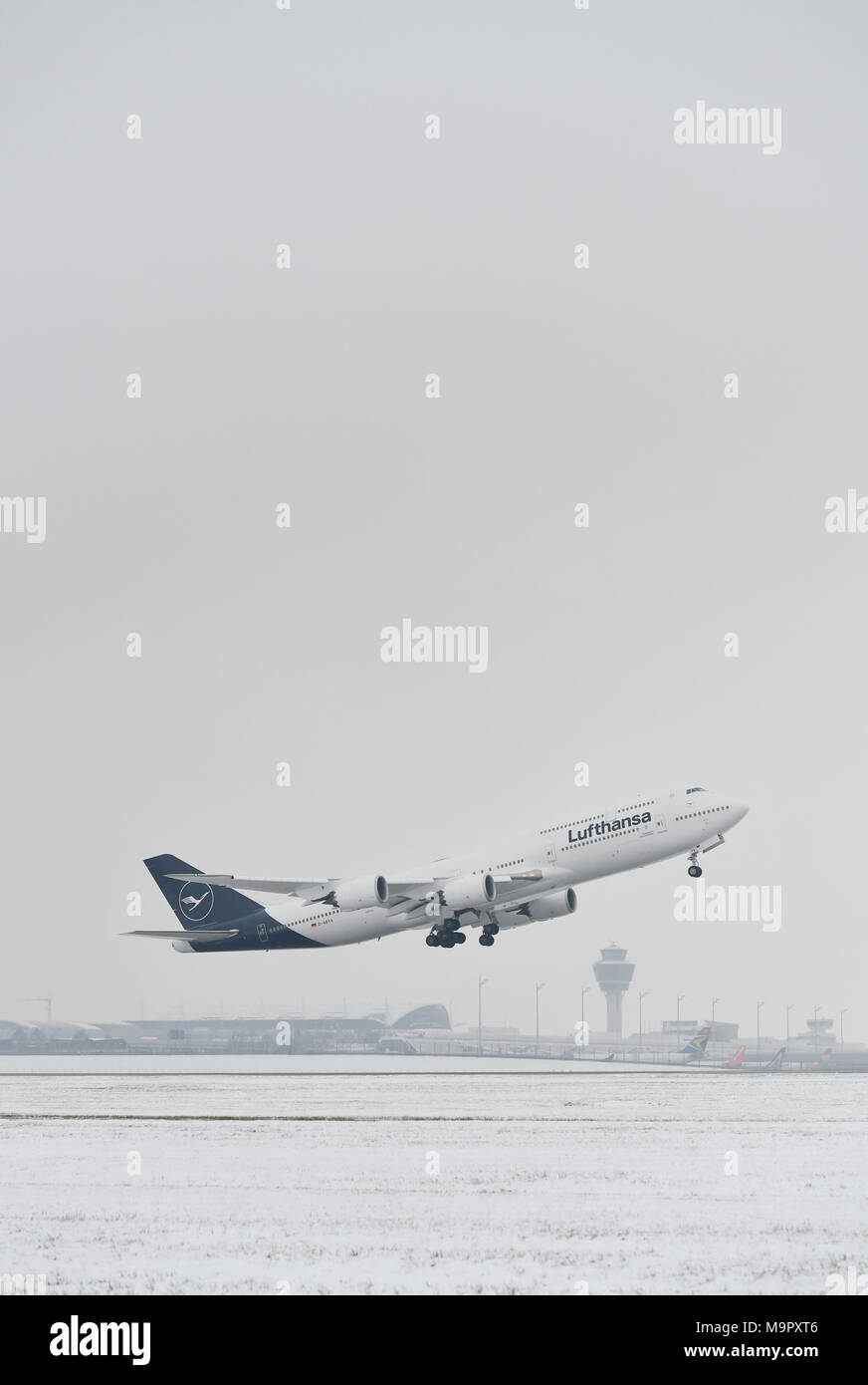 Lufthansa Boeing B747-800, take-off in snow with tower in the ...