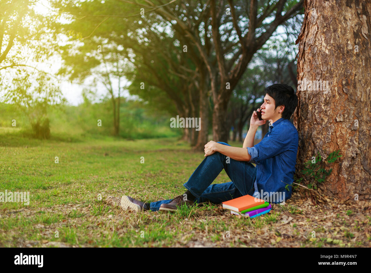 Korean smiling guy looking phone hi-res stock photography and images ...