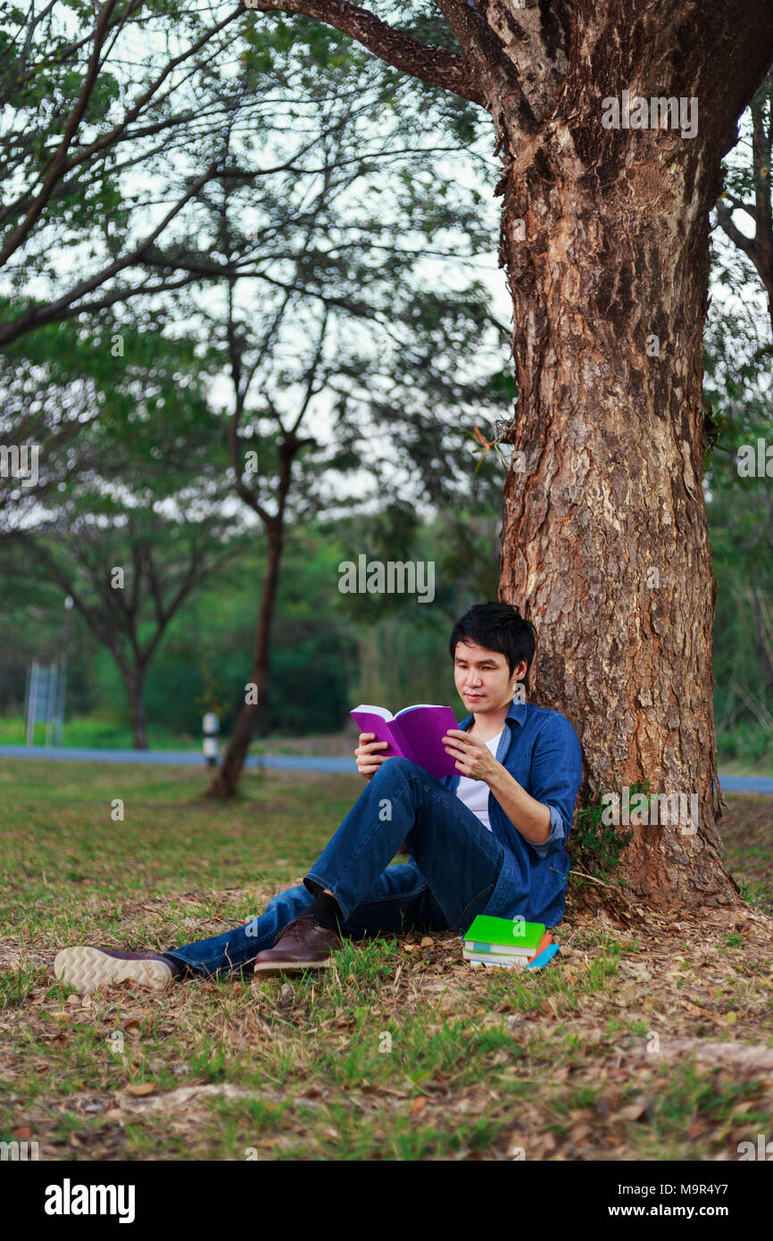 College student reading book outside hi-res stock photography and ...