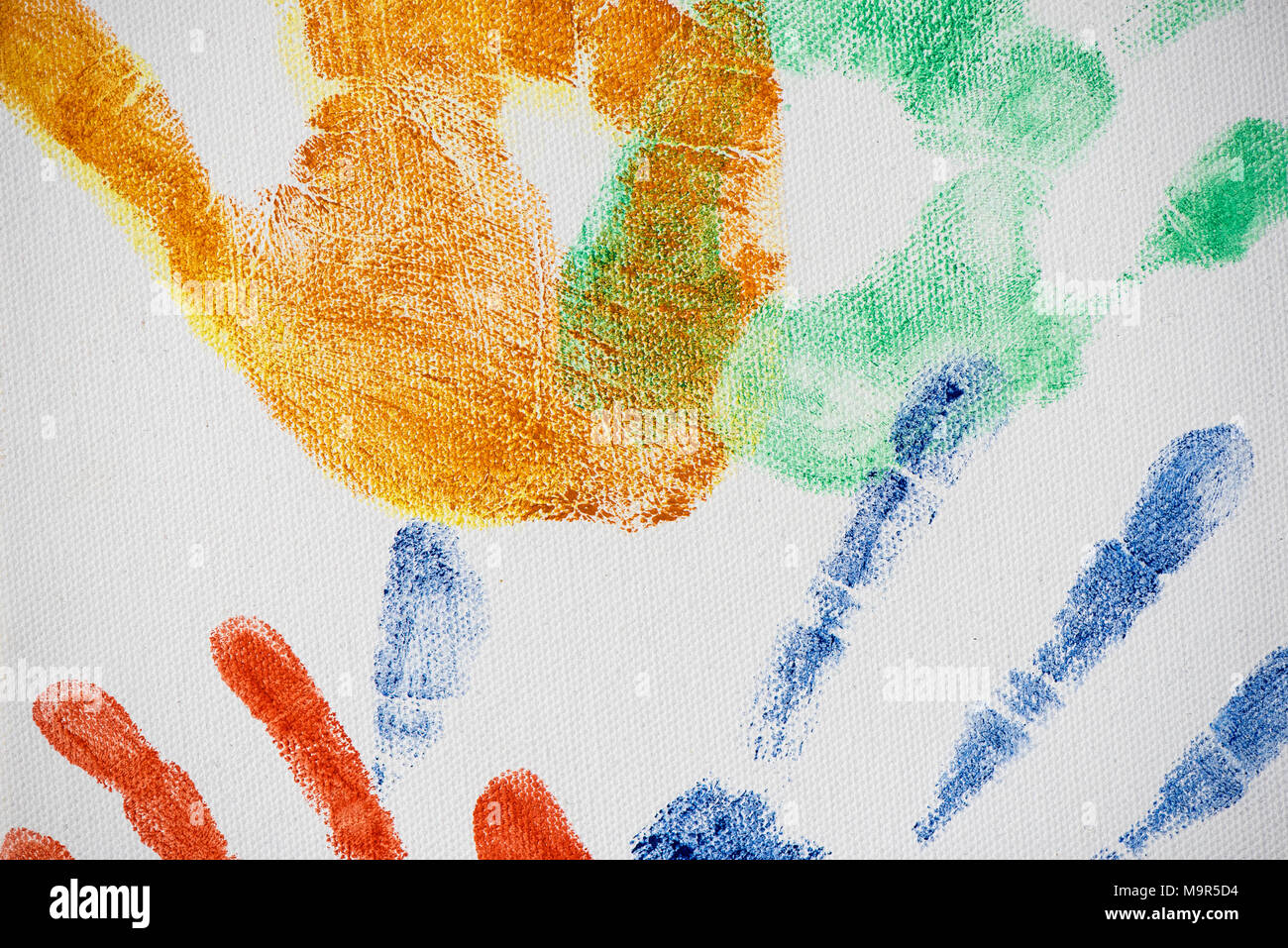 Colourful Handprints of various sizes on canvas Stock Photo - Alamy