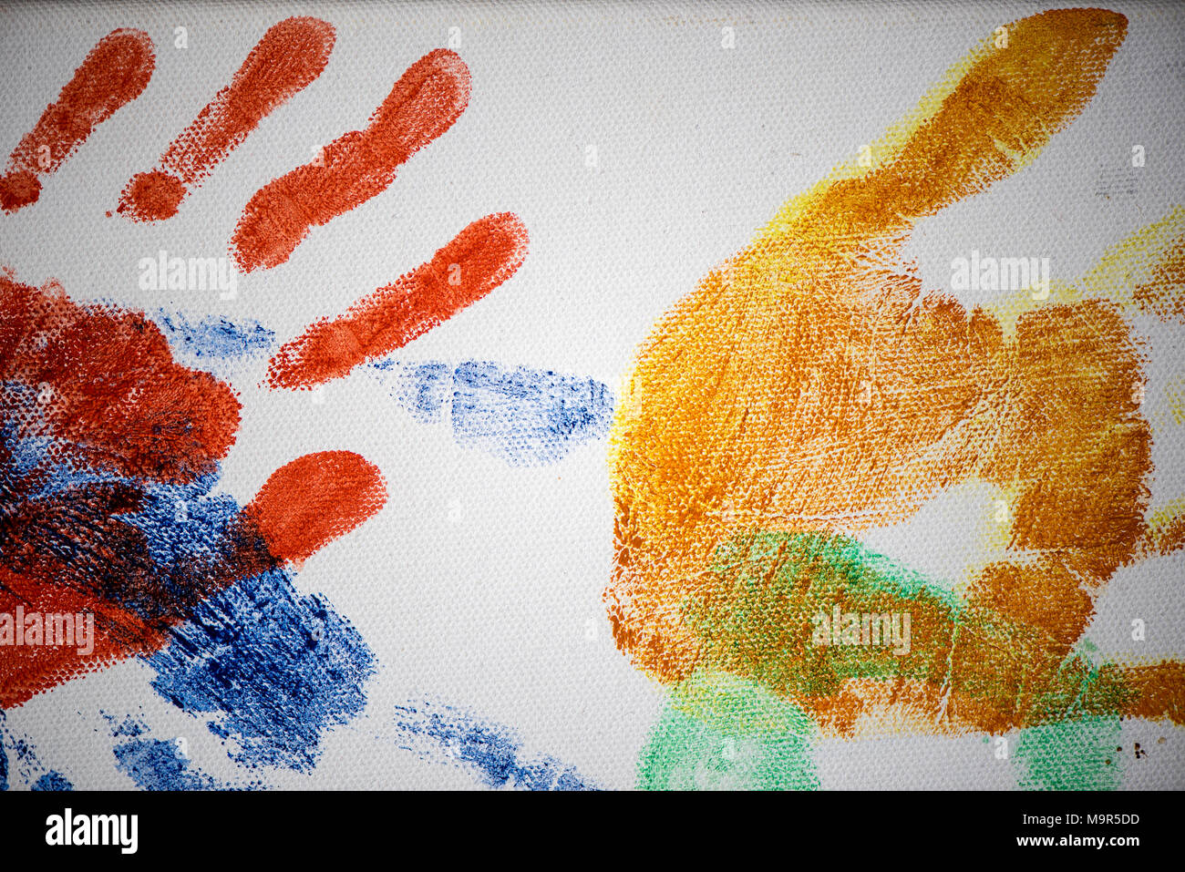 Colourful Handprints of various sizes on canvas Stock Photo - Alamy