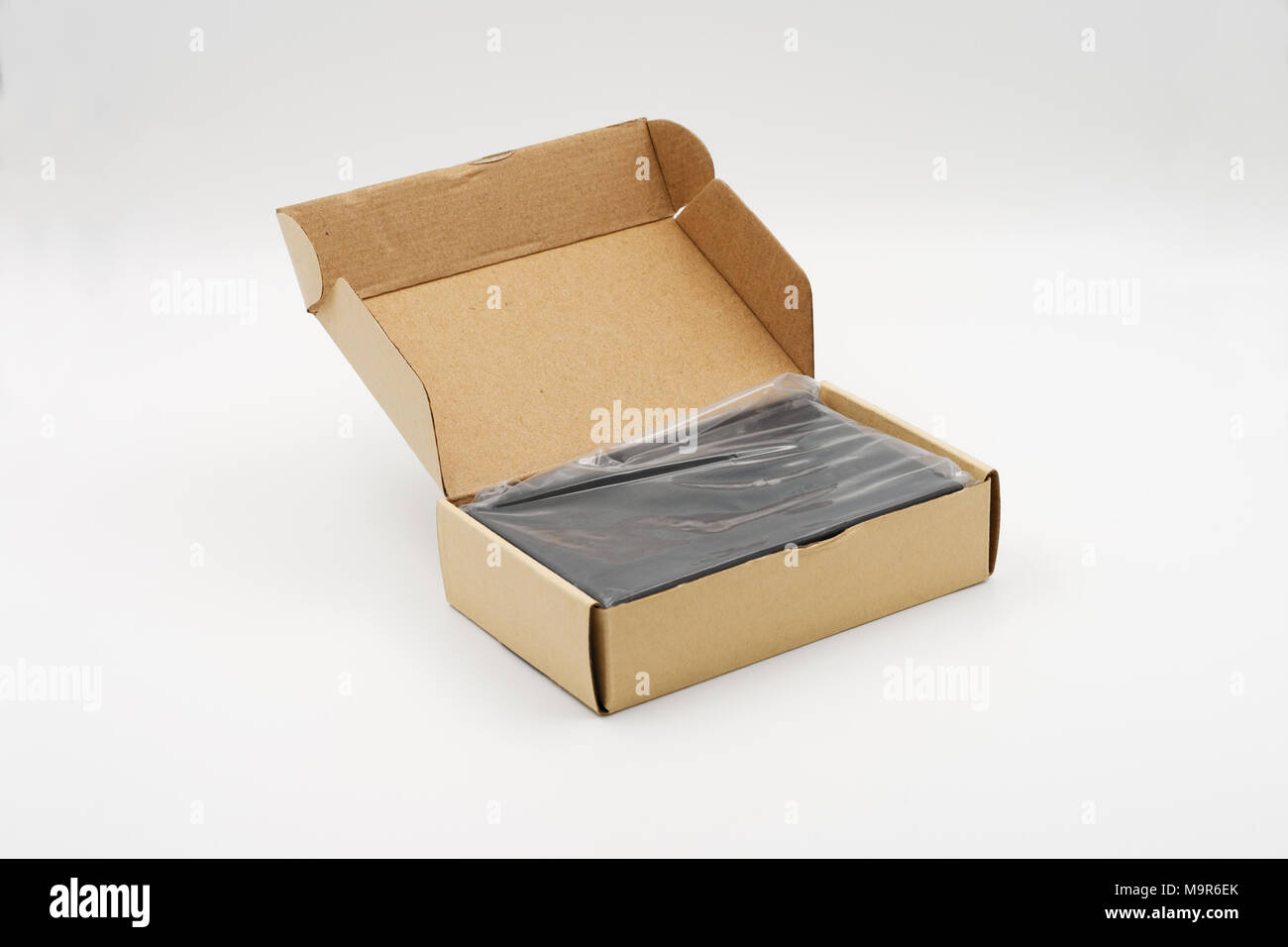External hard drive of the computer in a cardboard box. Isolated on ...
