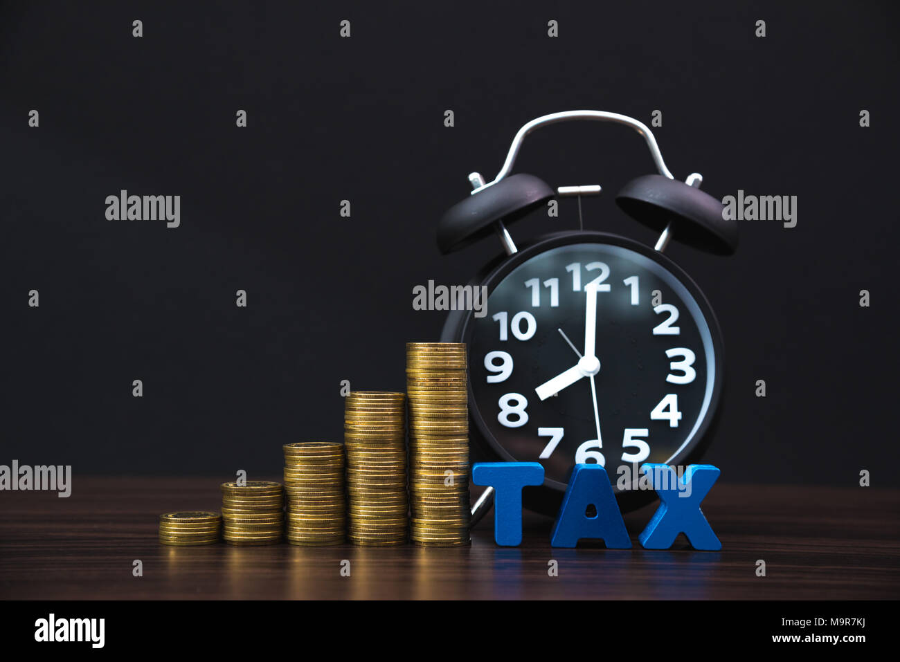 Time to pay TAX concept. TAX alphabet with stack of coin and vintage ...