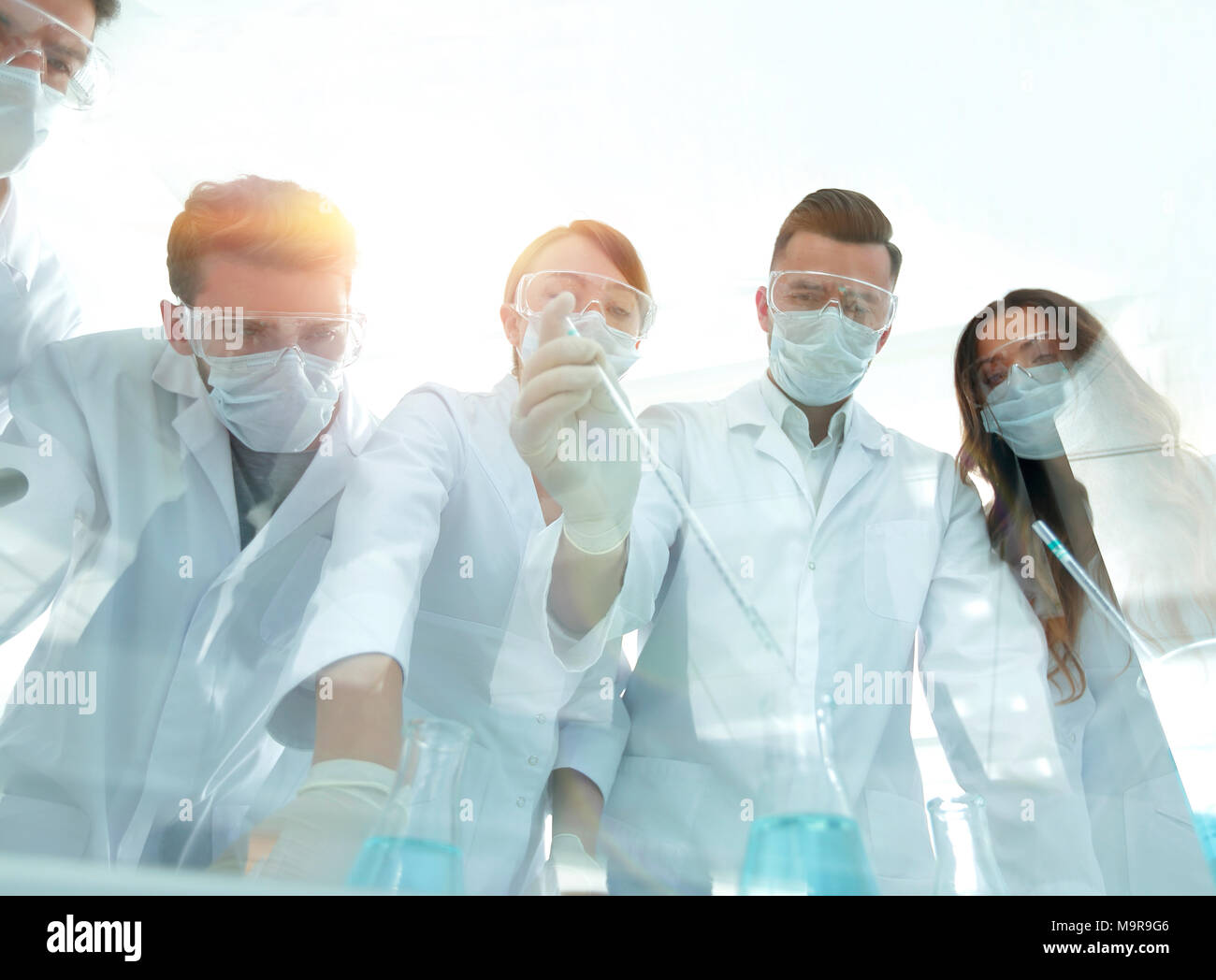 scientists working with test tubes and microscope in the laboratory ...