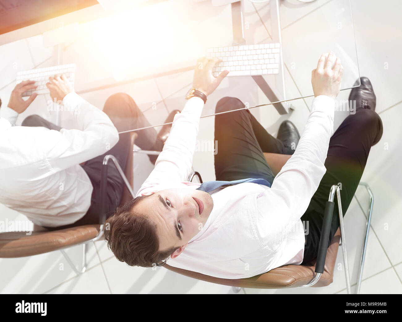 Boss sitting behind desk employees hi-res stock photography and images ...