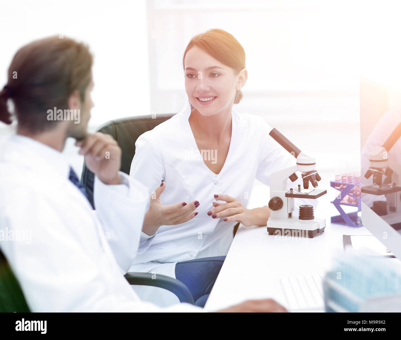 Side view of two scientists conducting a chemical experiment Stock ...