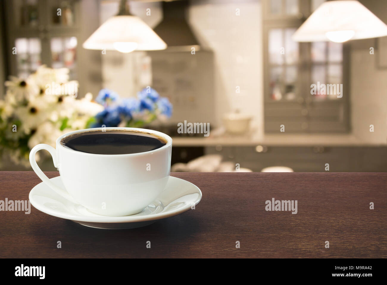 Hot cup of black coffee on wooden tabletop in modern kitchen Stock ...
