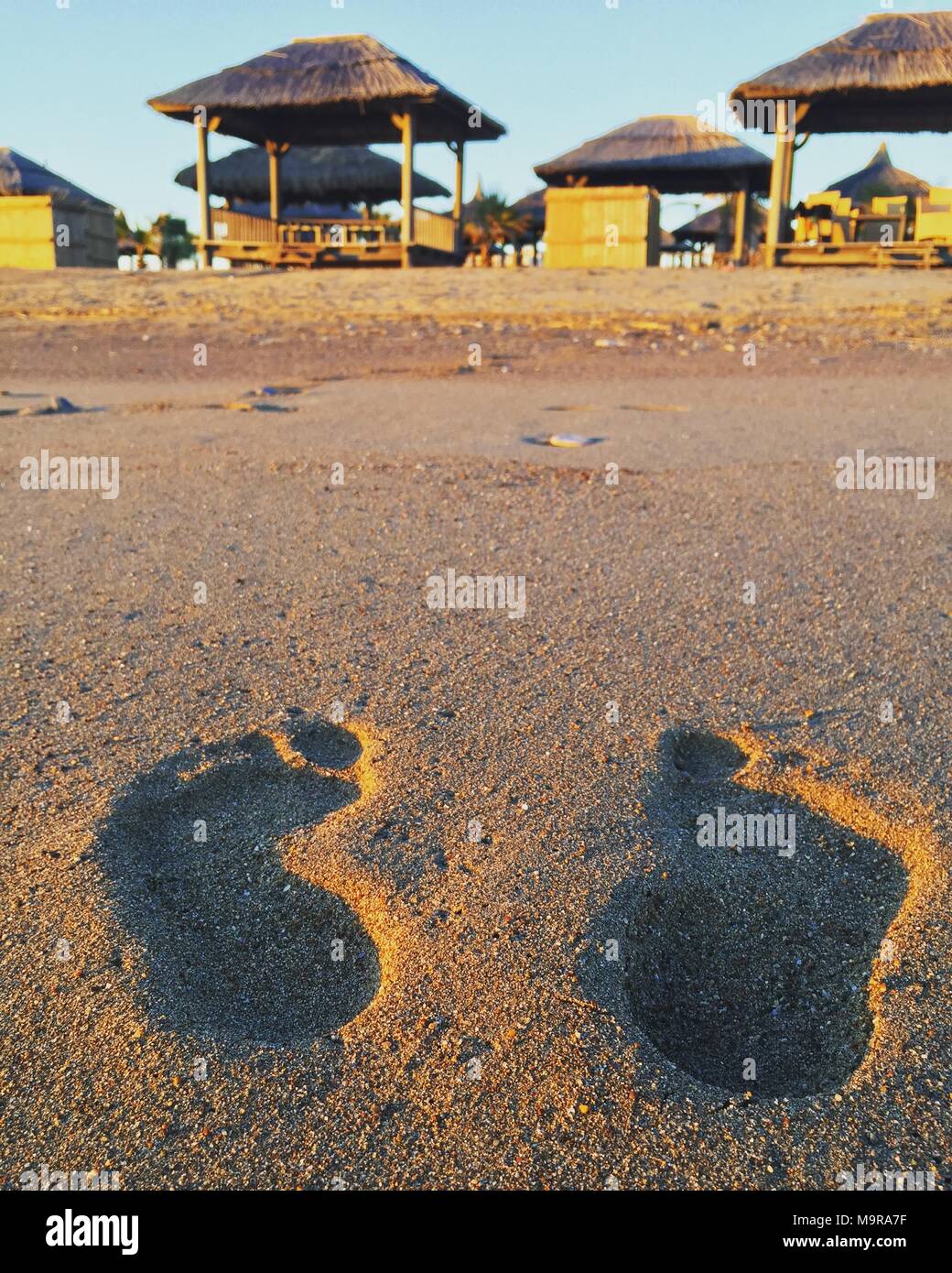Footprints in the sand at sunset. Beautiful sandy tropical beach with ...