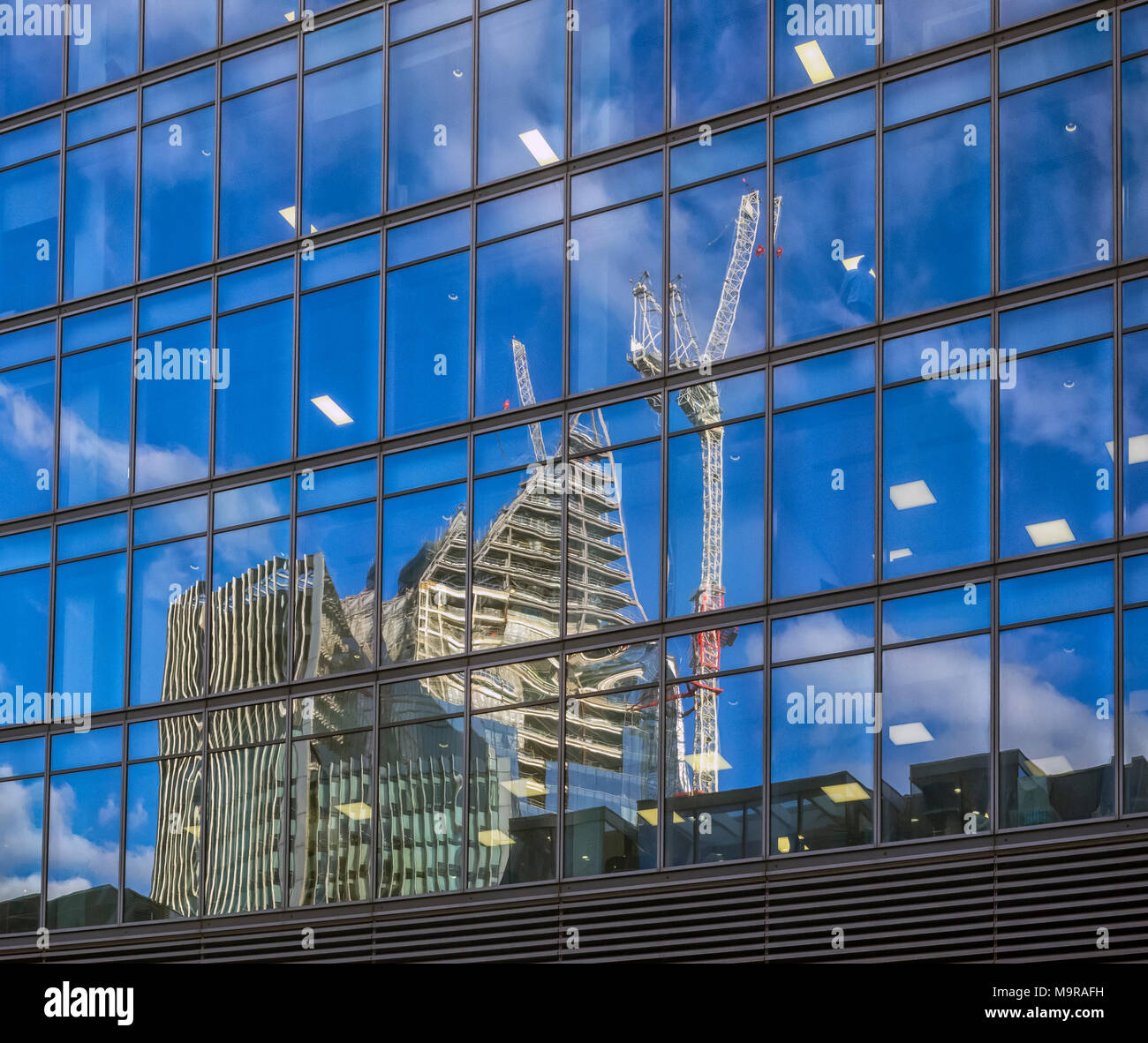 LONDON, UK - MARCH 08, 2018: Office Towers under construction reflected ...