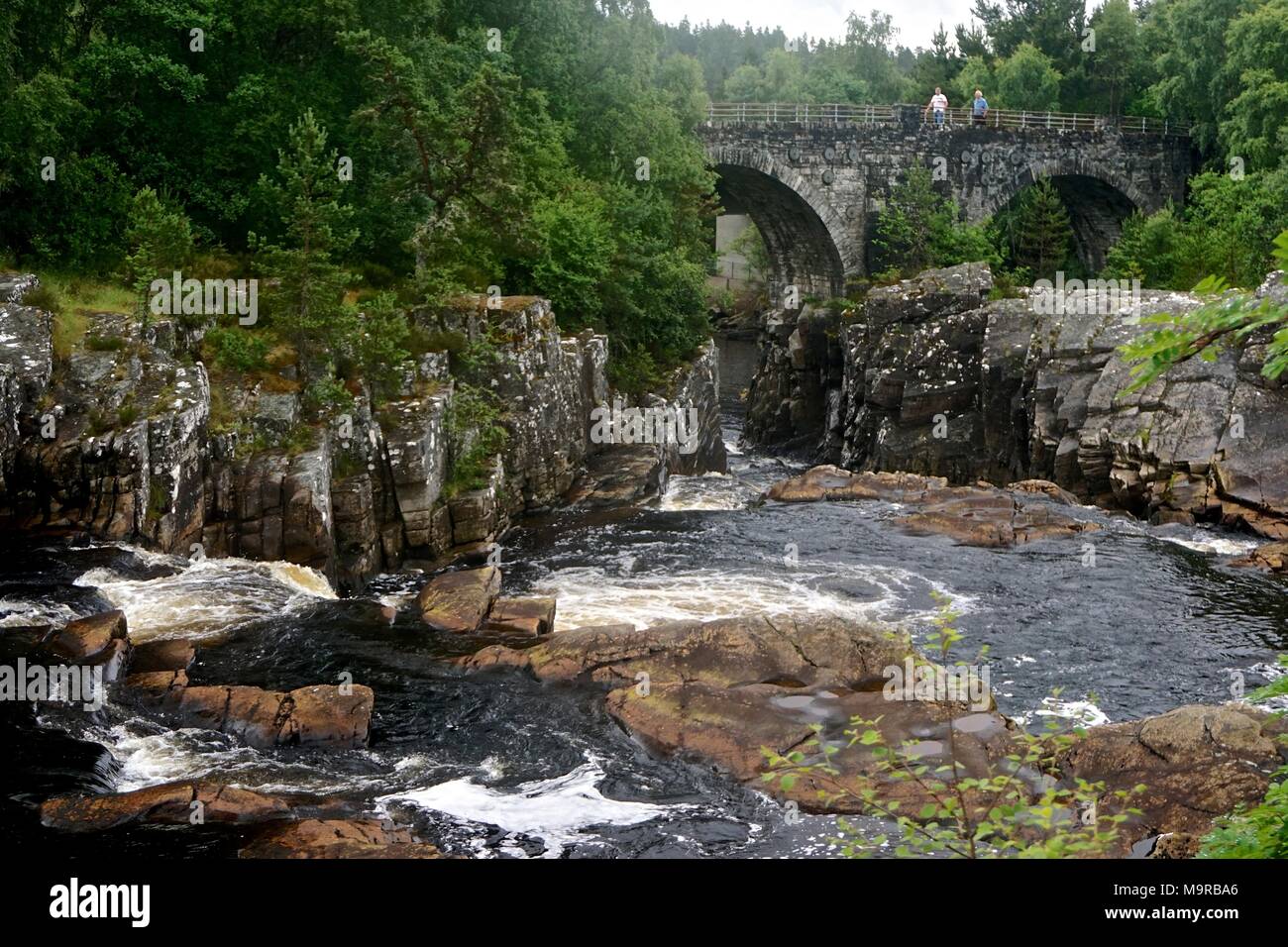 Garve, Scotland, United Kingdom: Two men walking on the Victorian-era ...