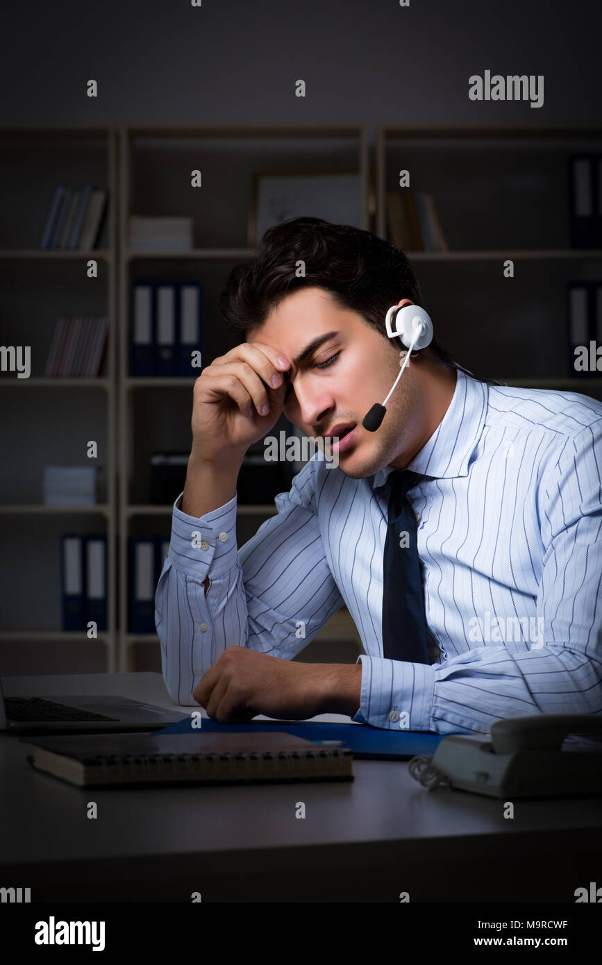 Tired and exhausted helpdesk operator during night shift Stock Photo ...
