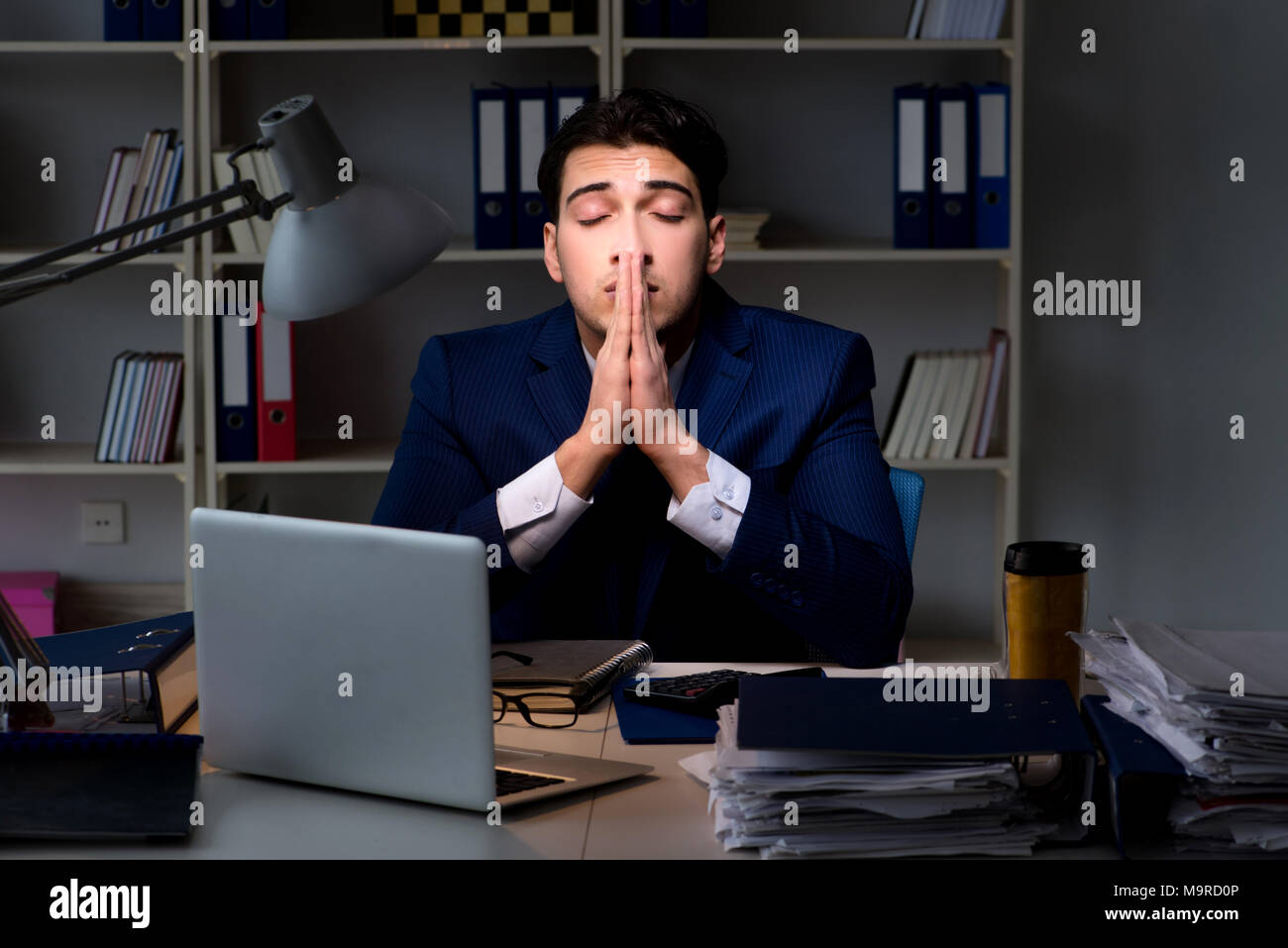 Employee working late to finish important deliverable task Stock Photo ...