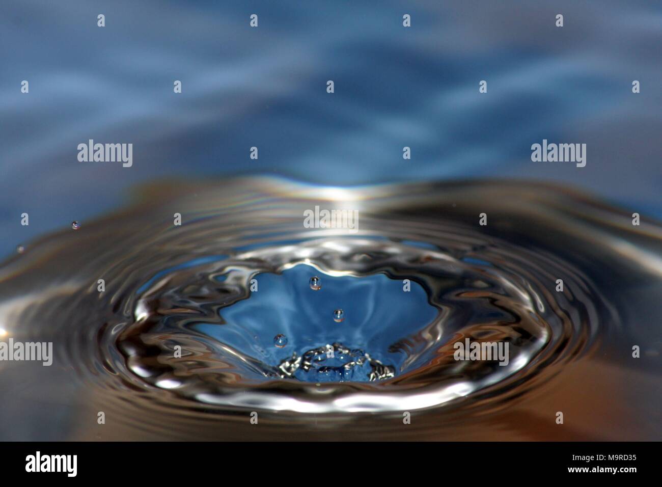 Splash, a drop falling in the water Stock Photo - Alamy