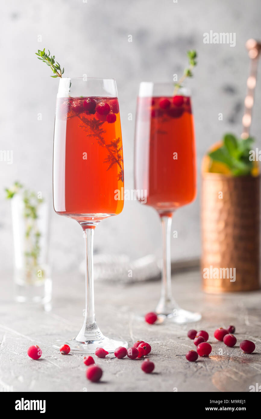 Colorful Red exotic alcoholic cocktail in champagne glasses over gray ...