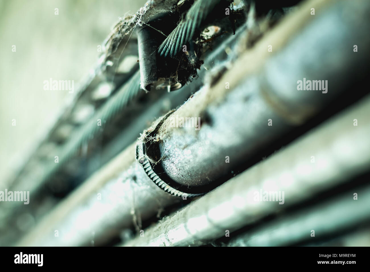 very dirty electrical cables along a dark concrete wall Stock Photo - Alamy