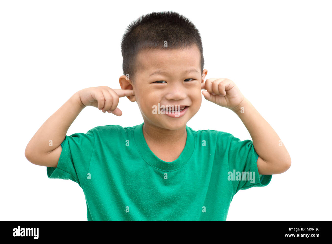 Asian child smiling and covering ears with hands. Portrait of young boy ...
