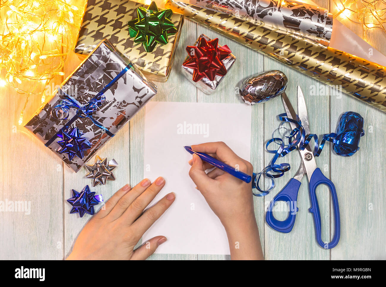Christmas composition with gifts, hands writing a letter Stock Photo ...
