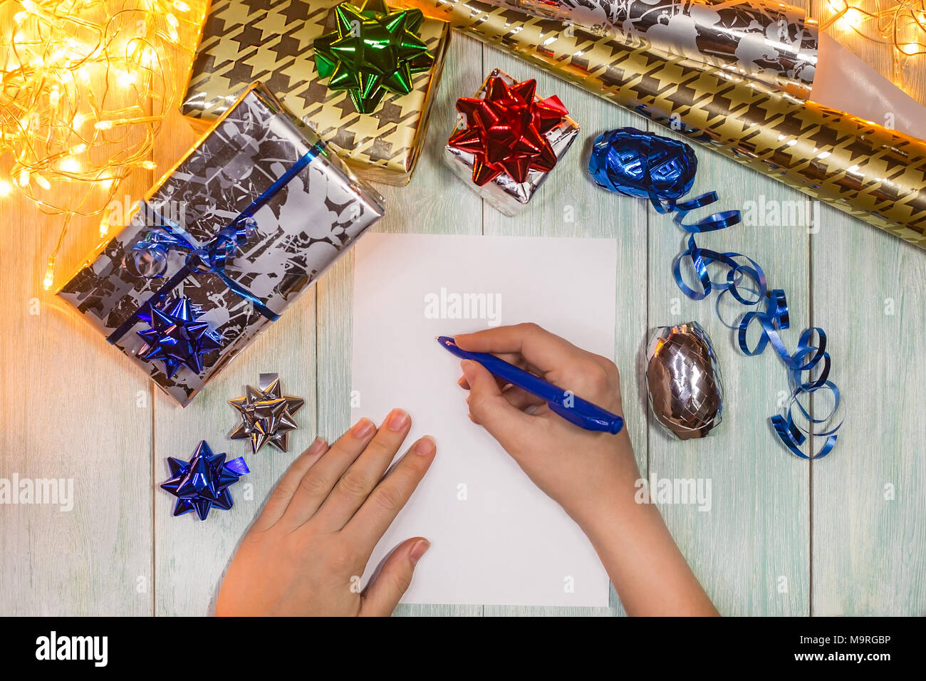 Christmas composition with gifts, hands writing a letter Stock Photo ...