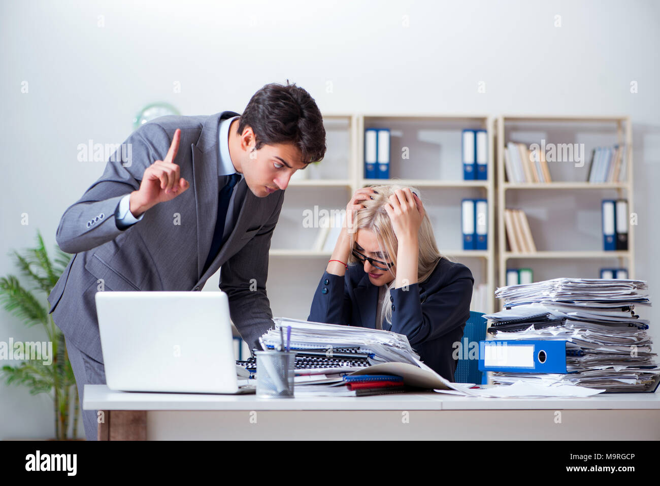 Angry irate boss yelling and shouting at his secretary employee Stock ...