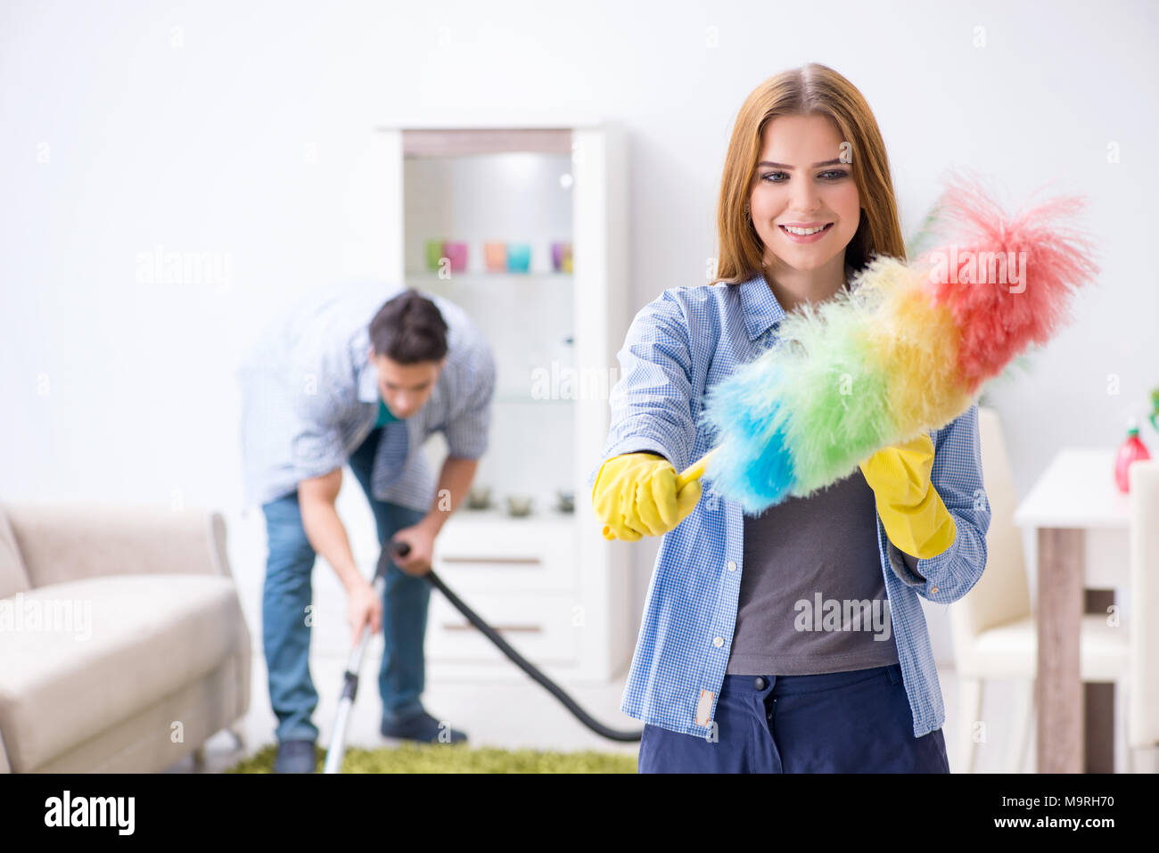 Young family cleaning the house Stock Photo - Alamy
