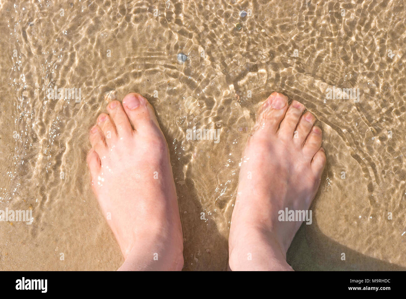 Concept human feet in water hi-res stock photography and images - Alamy