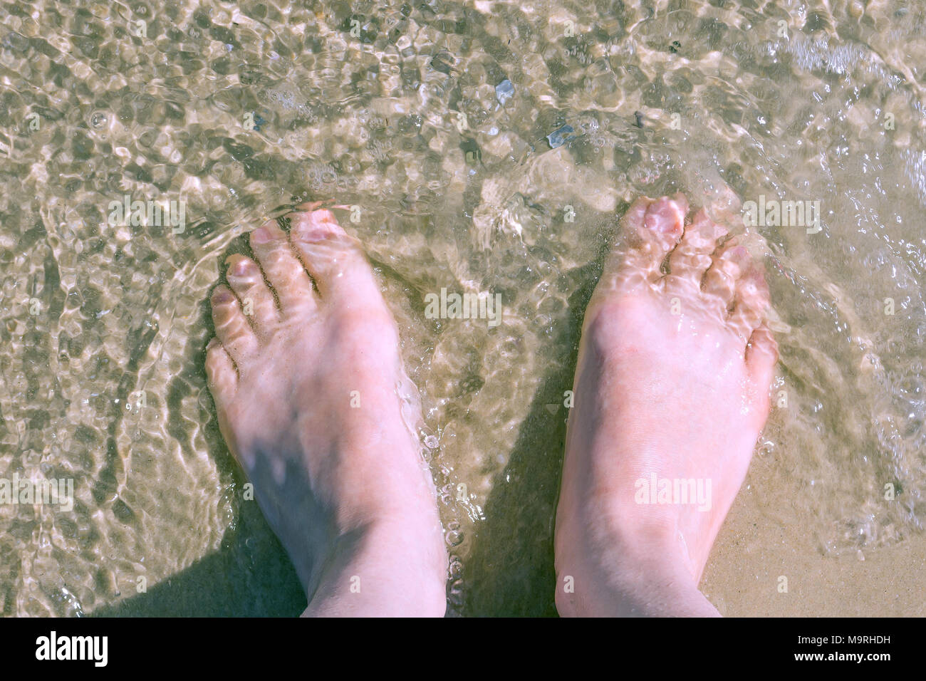 Woman toe in sea hi-res stock photography and images - Alamy
