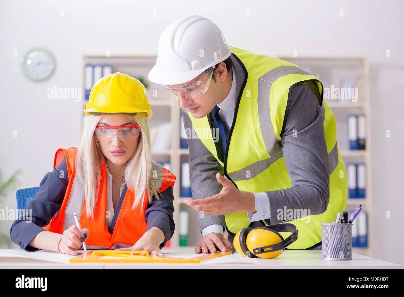 Construction workers having discussion in office before starting ...