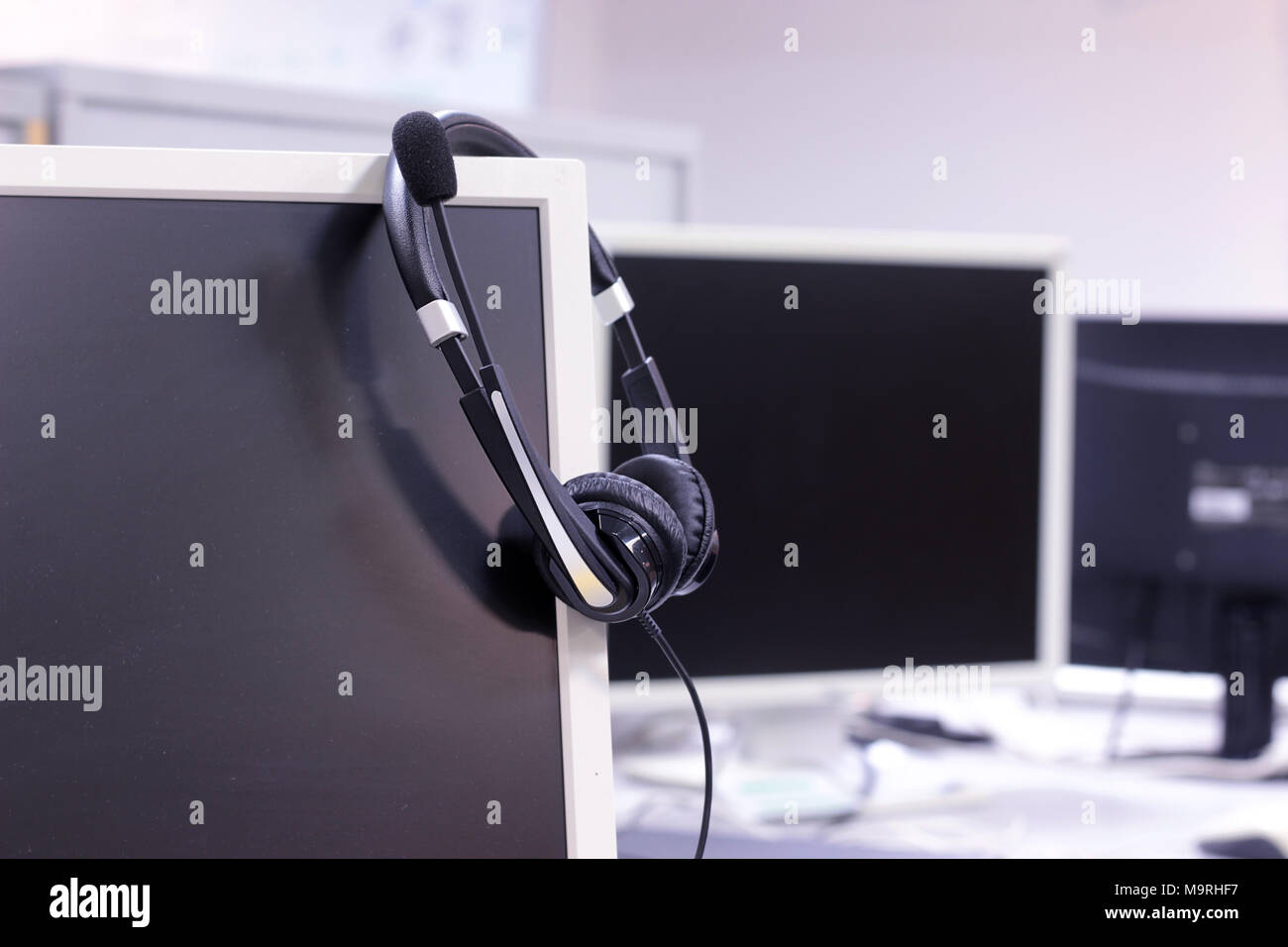 headset hanging over the monitor Stock Photo - Alamy