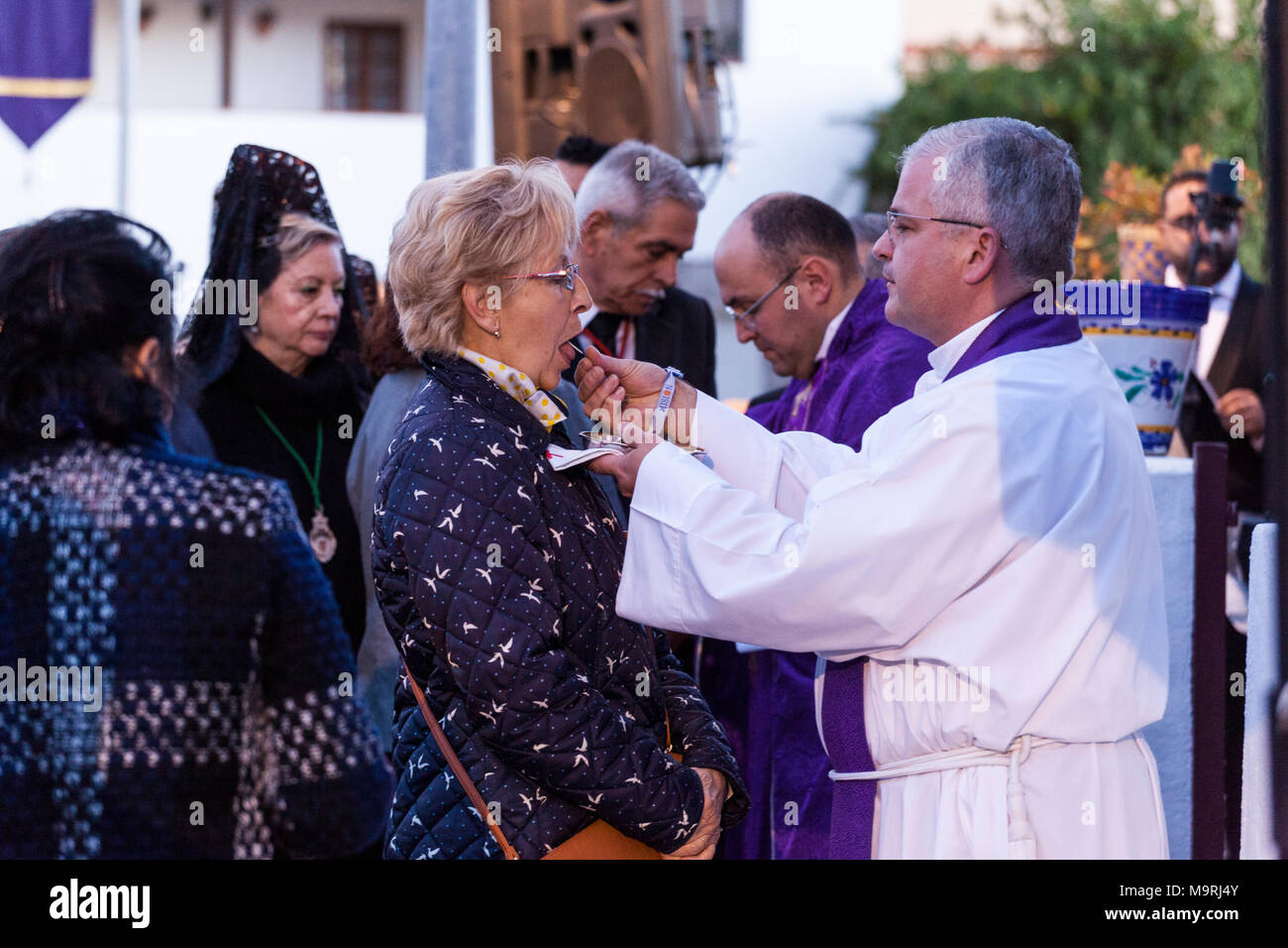 Priest giving communion hi-res stock photography and images - Alamy