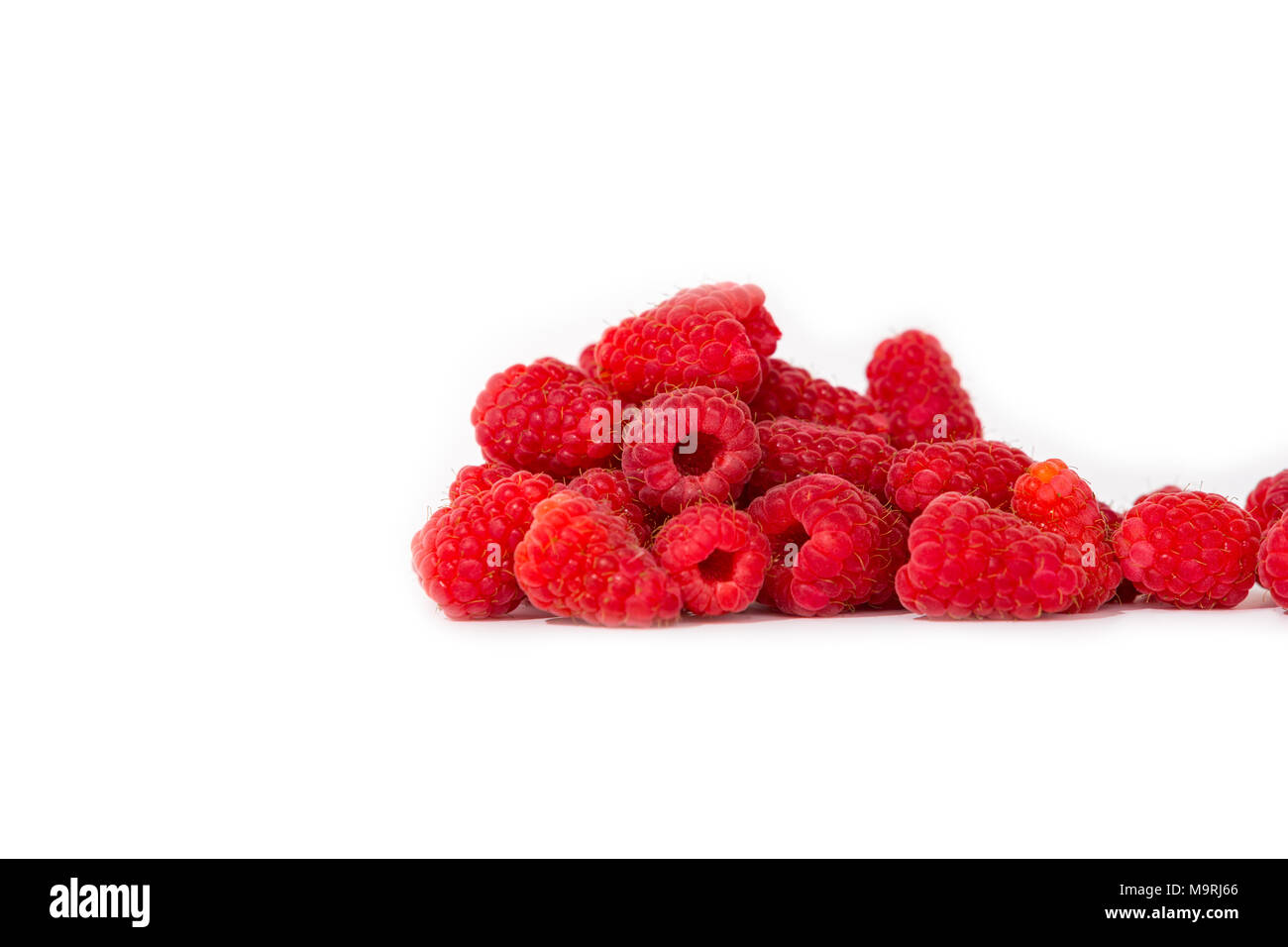 Stack of bright red fresh raspberries against white background Stock ...