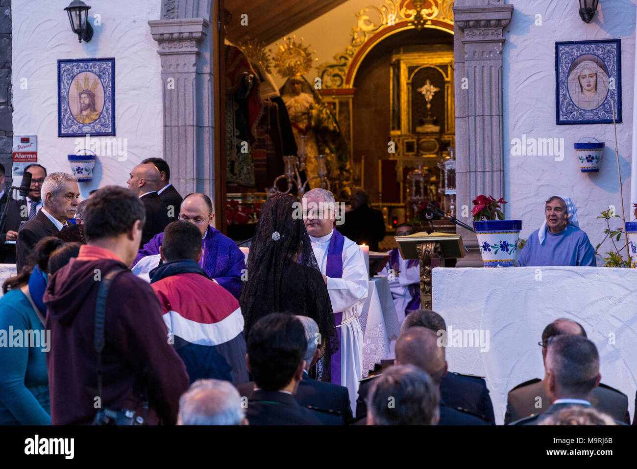 Priest celebrating mass, giving out communion host, unleavened bread ...