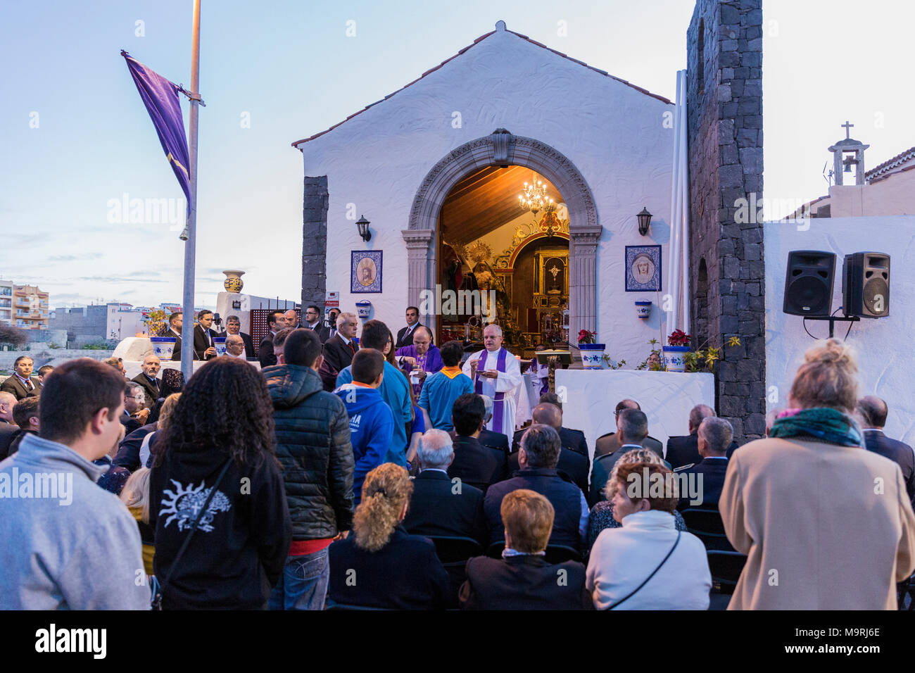 Priest celebrating mass, giving out communion host, unleavened bread ...