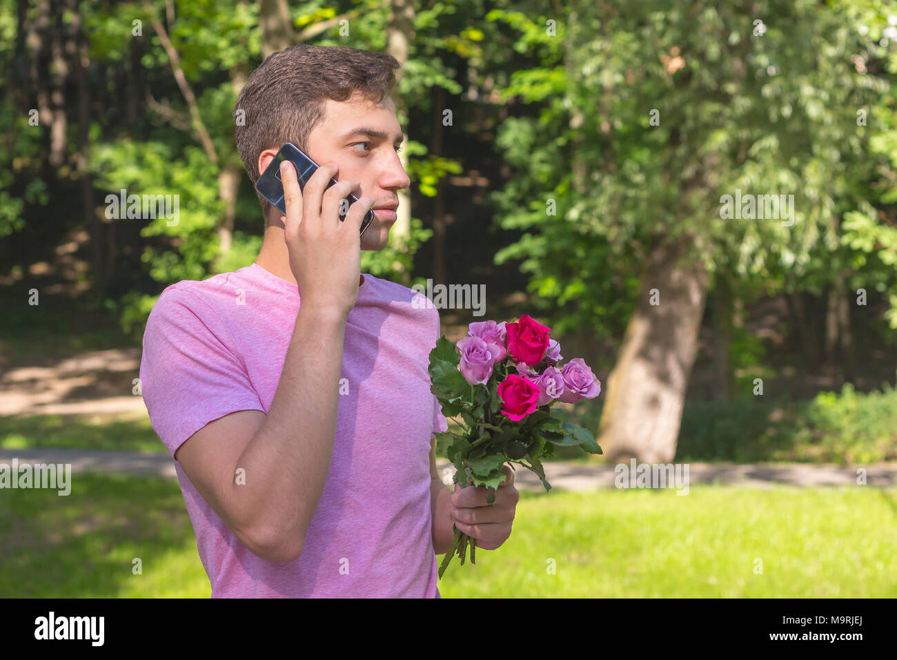 young men waiting date with roses calling Stock Photo - Alamy