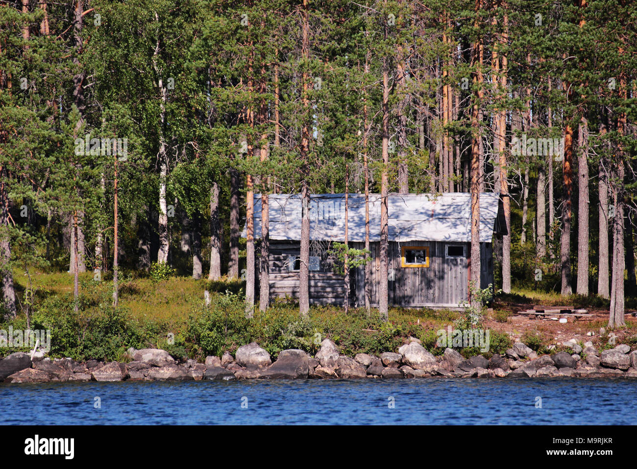 single wooden hunting house river bank in forest Stock Photo - Alamy