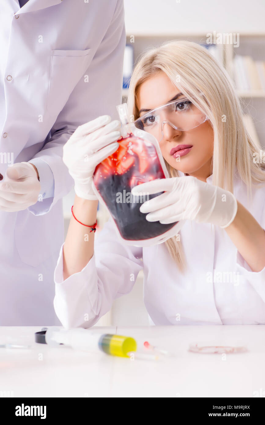 Woman female doctor looking at blood samples in bag Stock Photo - Alamy