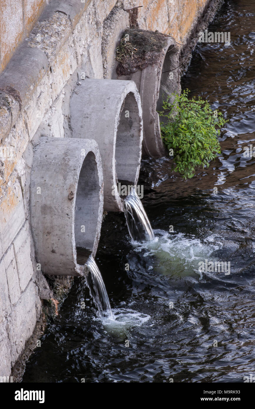 pipes pouring water in the river Stock Photo - Alamy