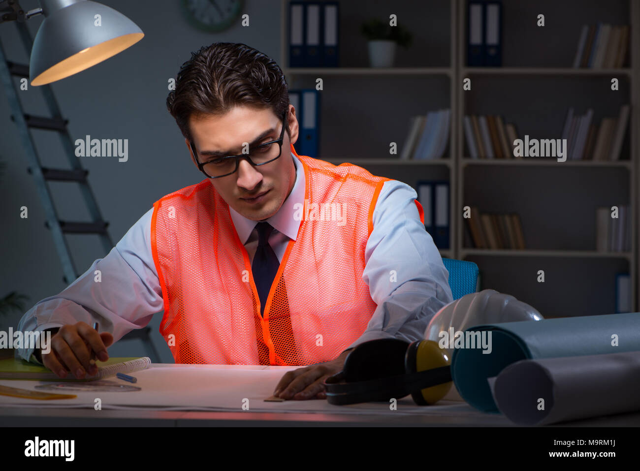 Construction architect working on drawings late at night Stock Photo ...
