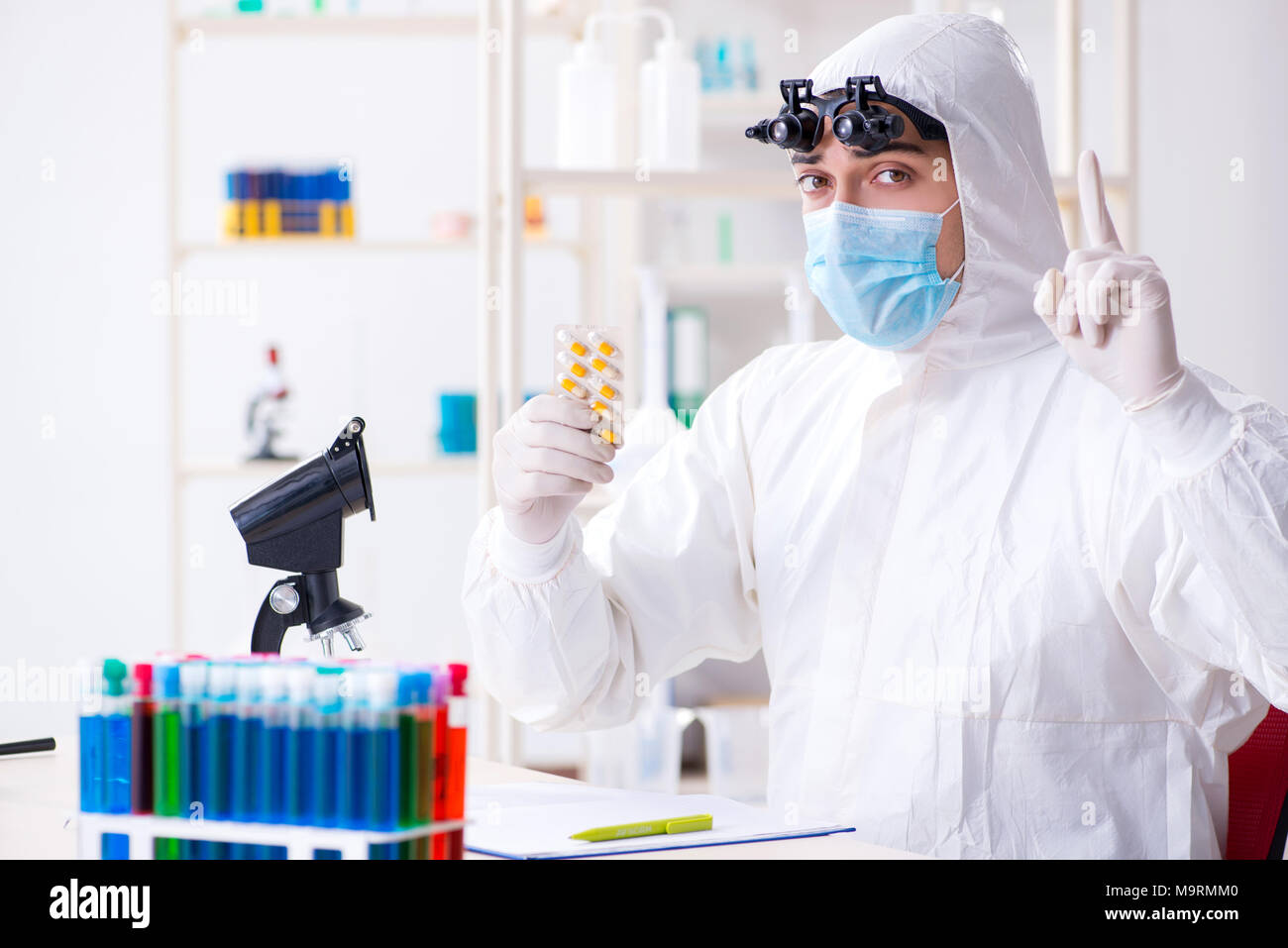 Drug synthesis concept with chemist working in research lab Stock Photo ...