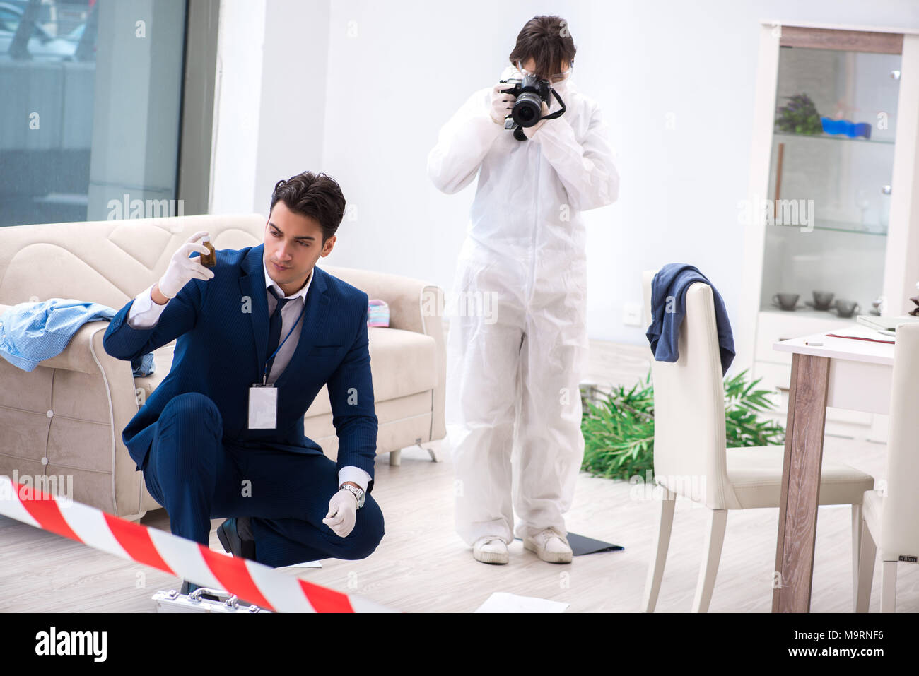Forensics investigator at the scene of office crime Stock Photo - Alamy